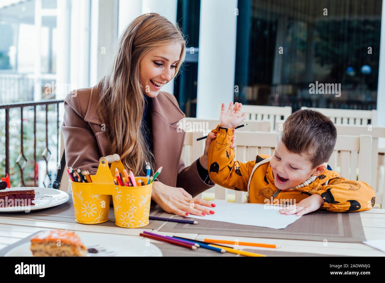 mom helps son to draw drawing colored pencils Stock Photo - Alamy