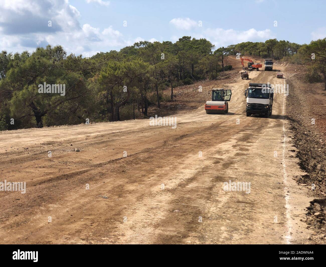 Earthworks of highland forest road. Different types of machinery on the ...