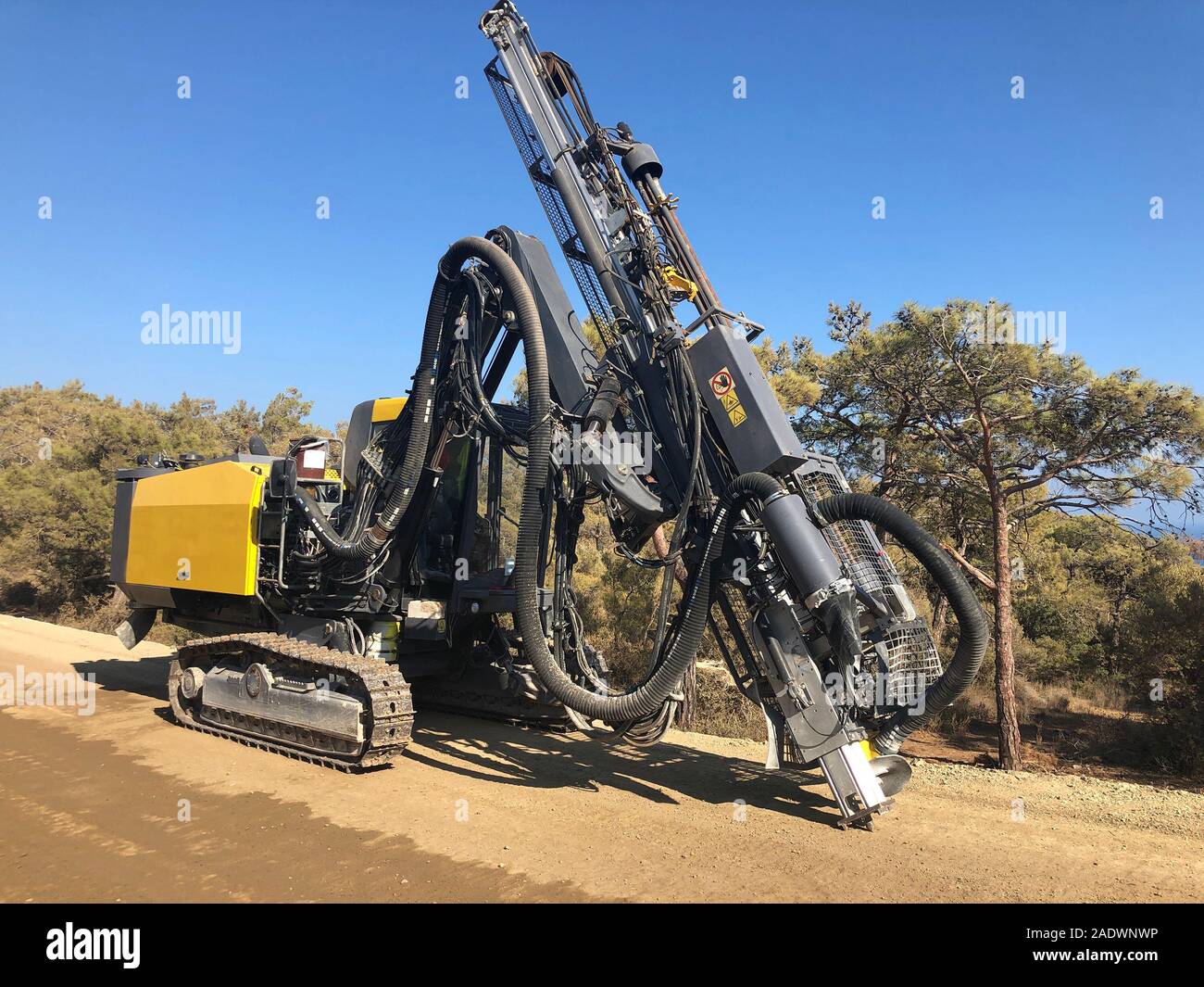 Yellow machinery for drilling holes during blasthole drilling ...