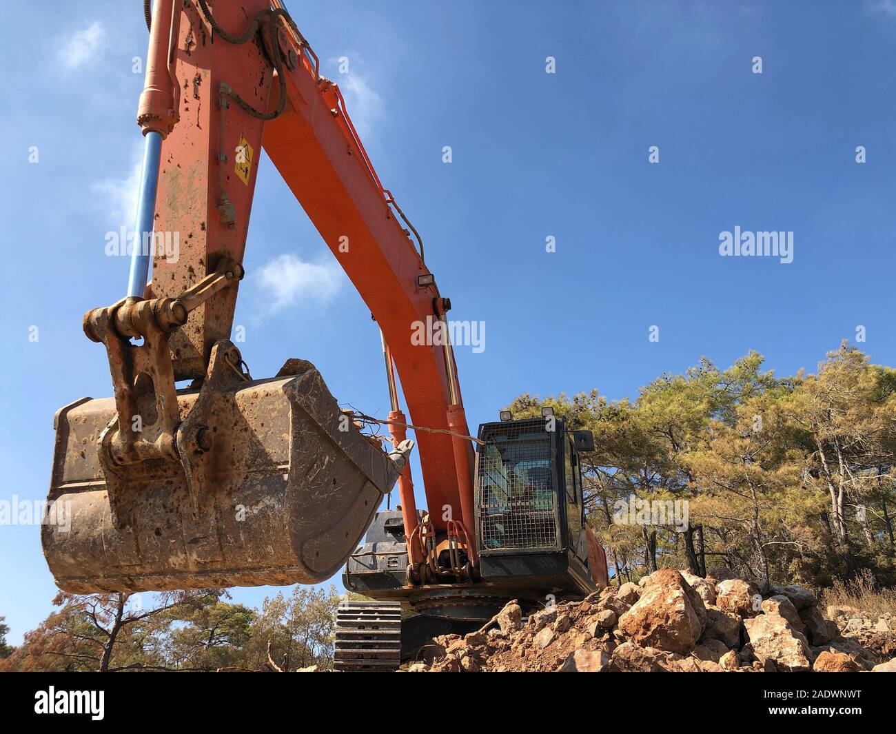 Excavator scoop loading a soil during road construction. Load angle ...