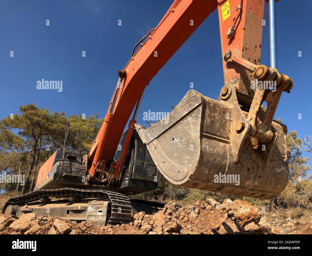 Excavator scoop loading a soil during road construction. Load angle ...