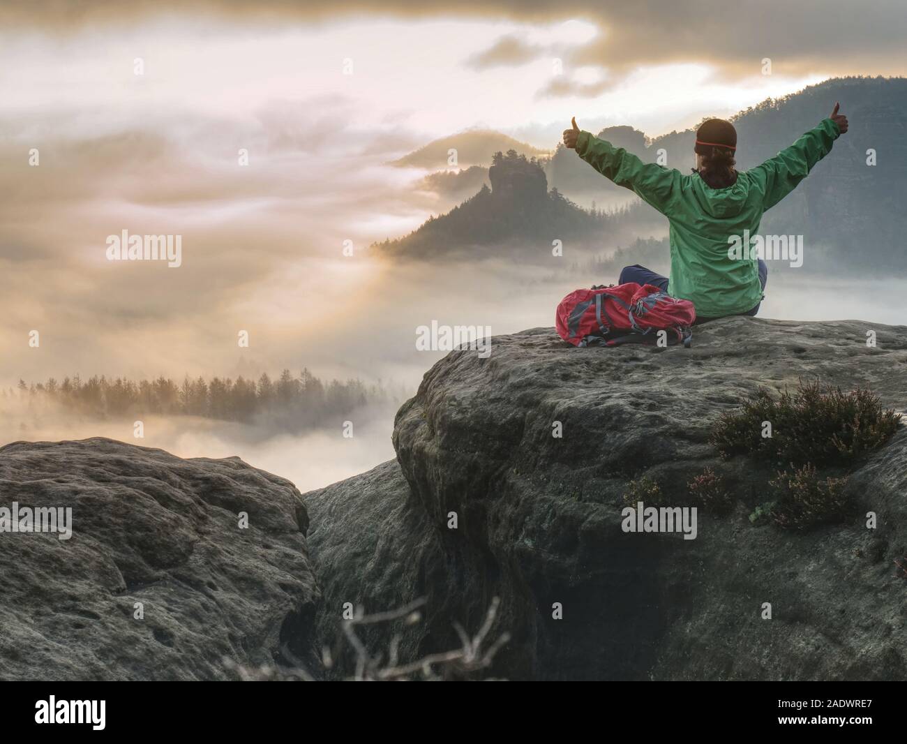 Happy sitting woman raised arms over head and celebrate life. Girl in ...