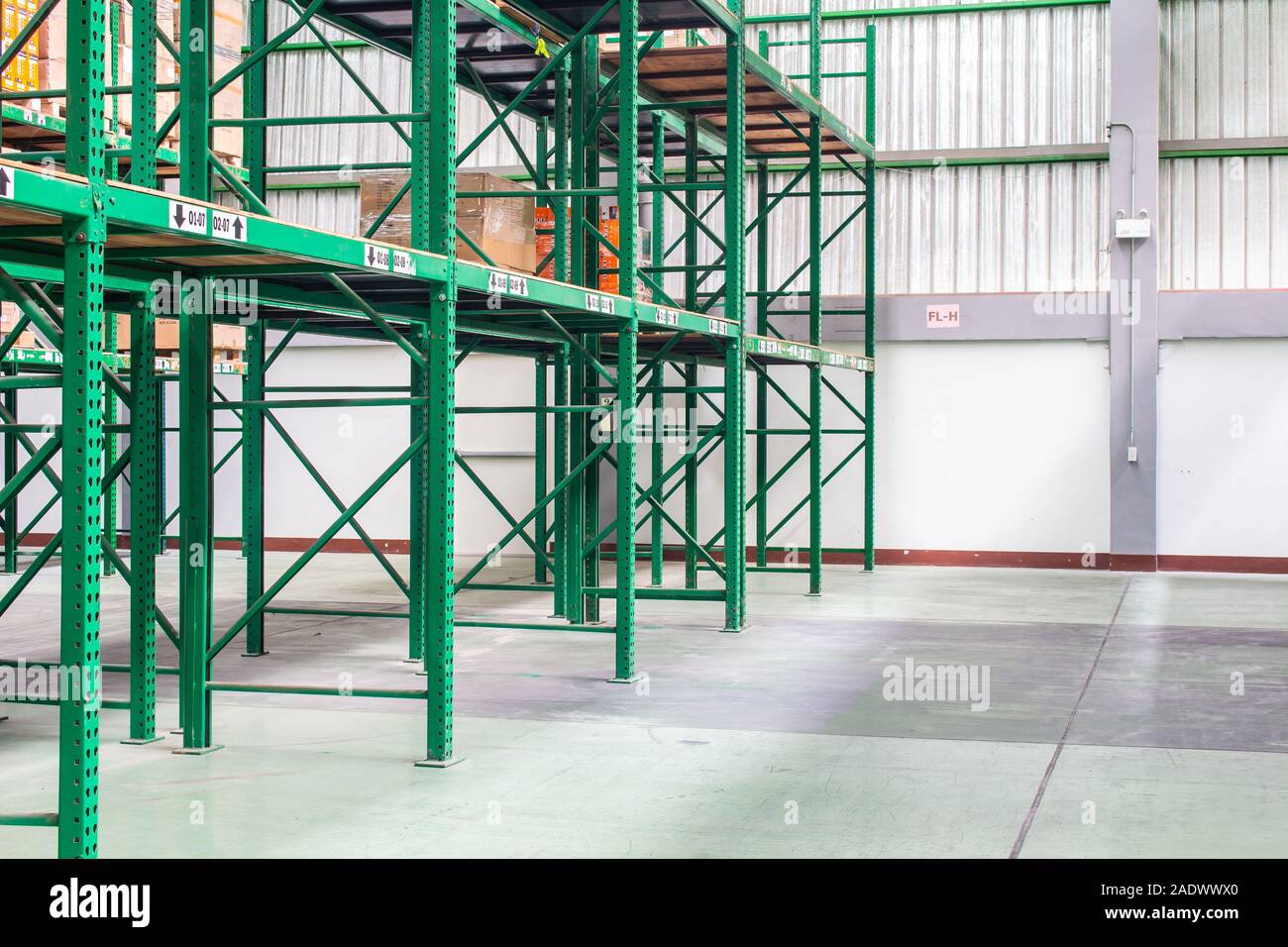 The rows of shelves with boxes in warehouse Stock Photo - Alamy