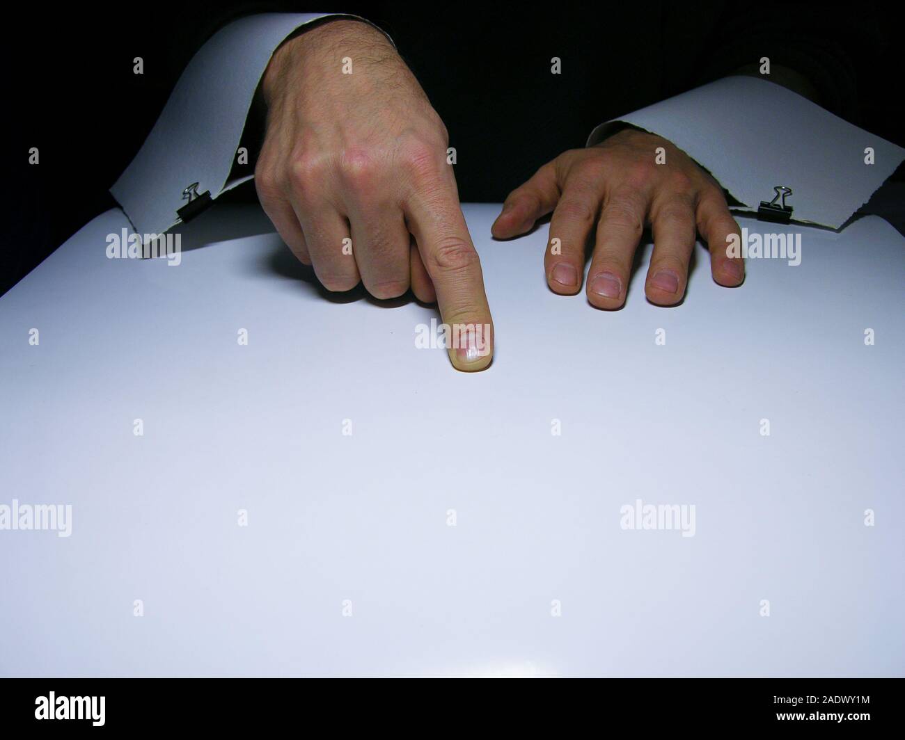 Man's hands in paper cuffs fastened with metal clips Stock Photo - Alamy