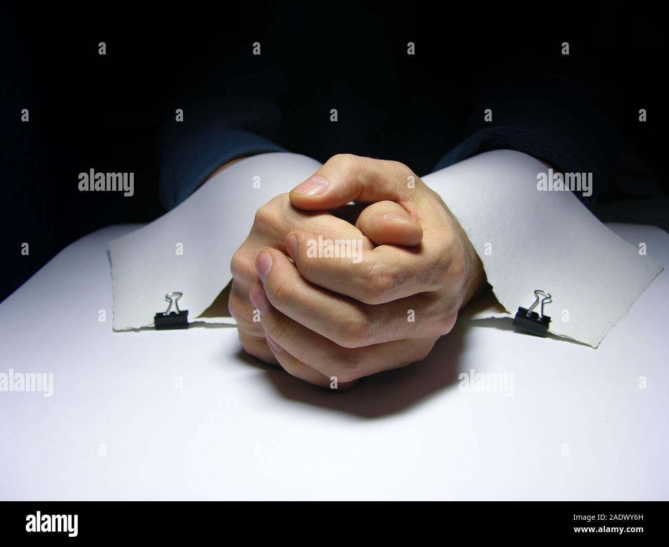 Man's hands in paper cuffs fastened with metal clips Stock Photo - Alamy