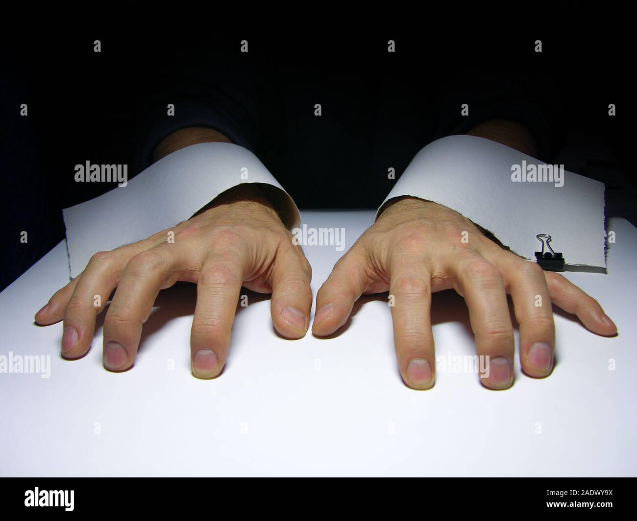 Man's hands in paper cuffs fastened with metal clips Stock Photo - Alamy