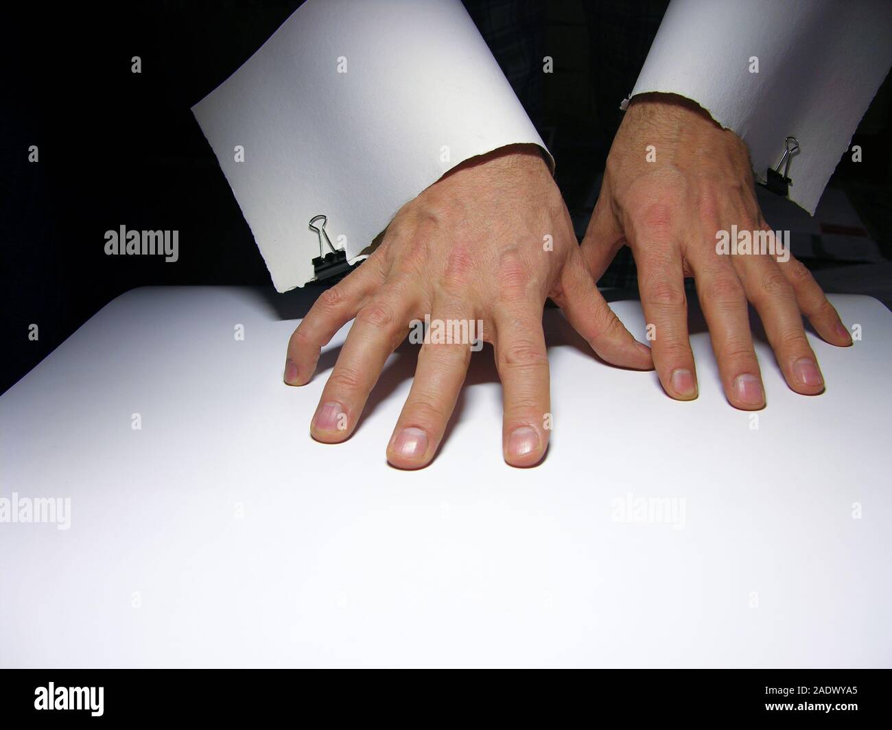 Man's hands in paper cuffs fastened with metal clips Stock Photo - Alamy