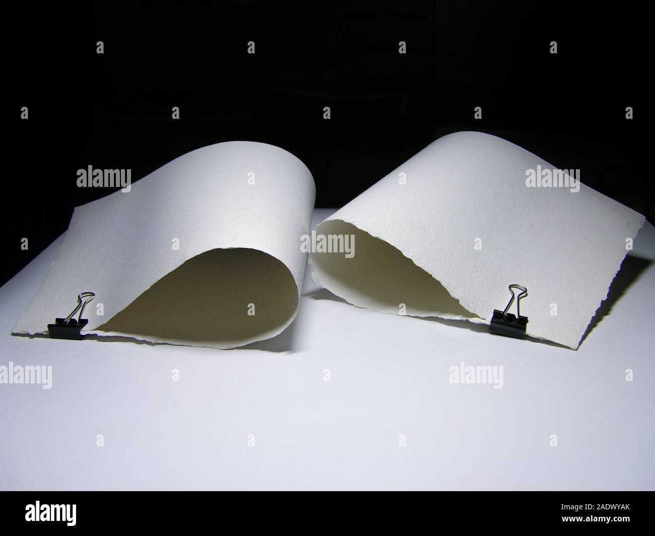 Paper cuffs fastened with metal clips Stock Photo - Alamy