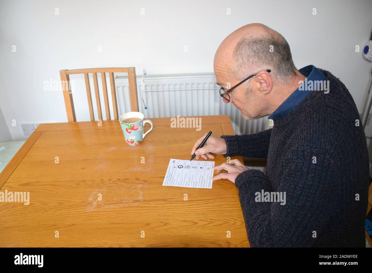Man completing his postal vote - general election December 2019 UK. MR ...