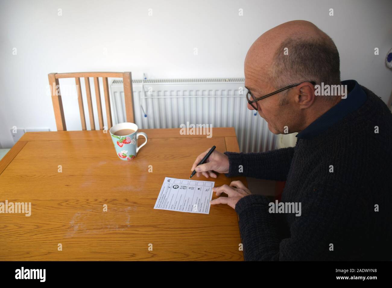 Man completing his postal vote - general election December 2019 UK. MR ...