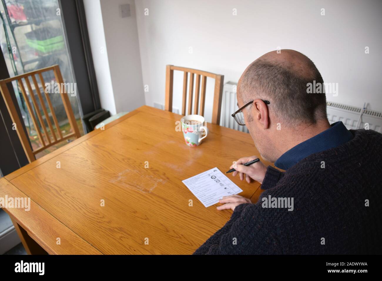 Man completing his postal vote - general election December 2019 UK. MR ...