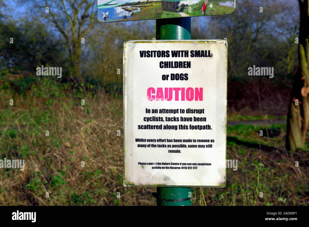 Visitor caution sign,attempt to disrupt cyclists,tacks scattered along ...