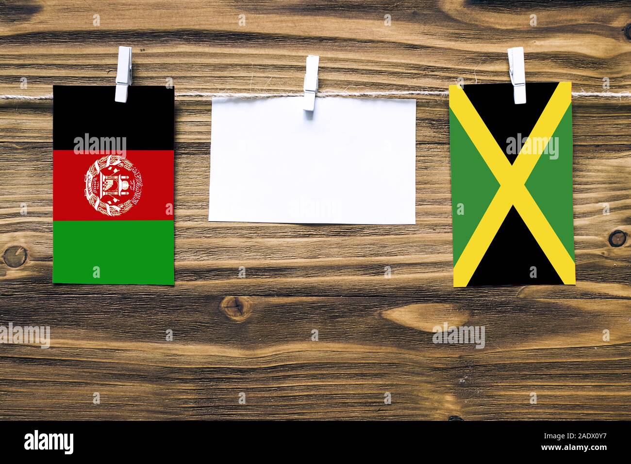 Hanging flags of Afghanistan and Jamaica attached to rope with clothes ...