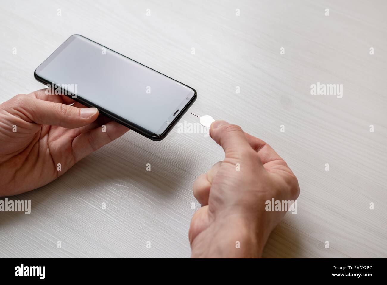 Eject SIM and mini SD card from phone with pin, ejector tool Stock ...