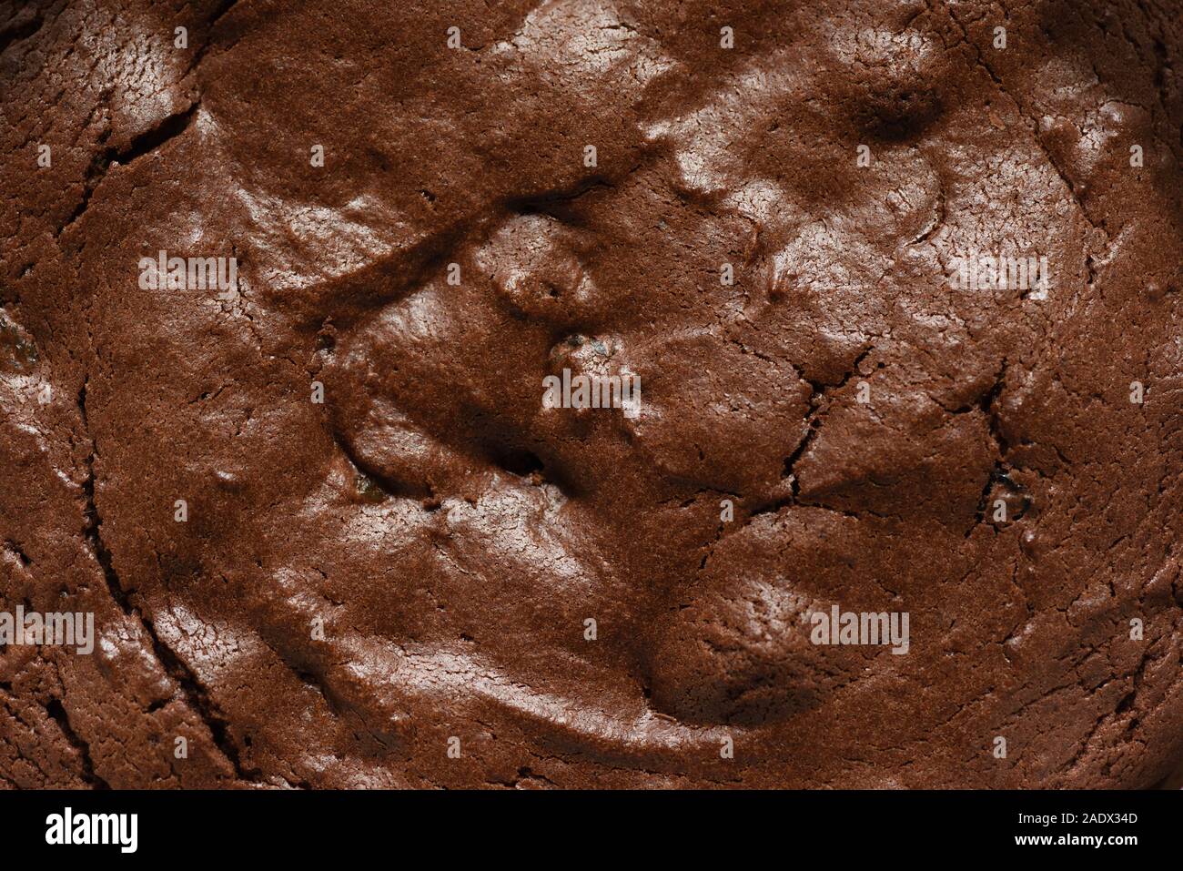 Freshly baked chocolate cake surface texture as background closeup ...