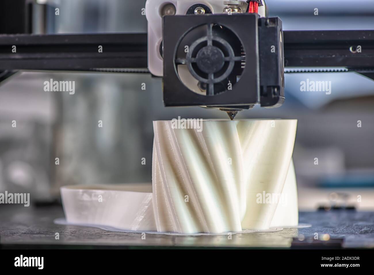The 3D printer prints the model out of white plastic. modern technology ...