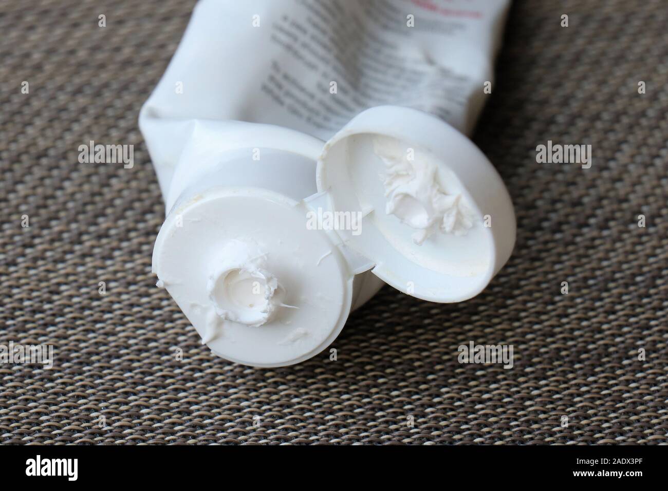Whitening toothpaste with open lid on pattern background Stock Photo ...