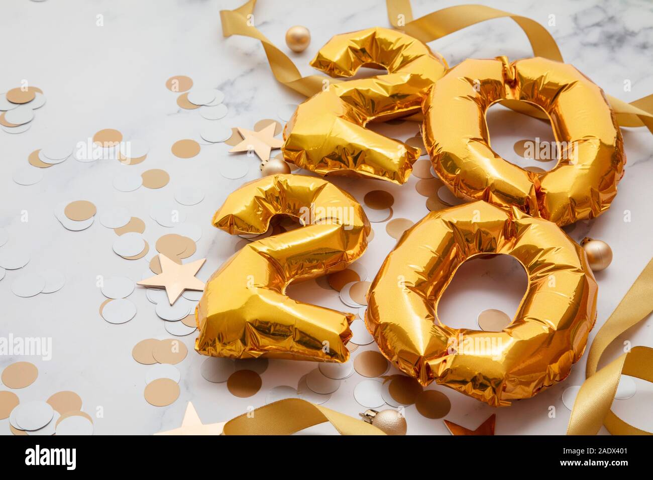 2020 New year party celebration. Gold foil party balloons with ...