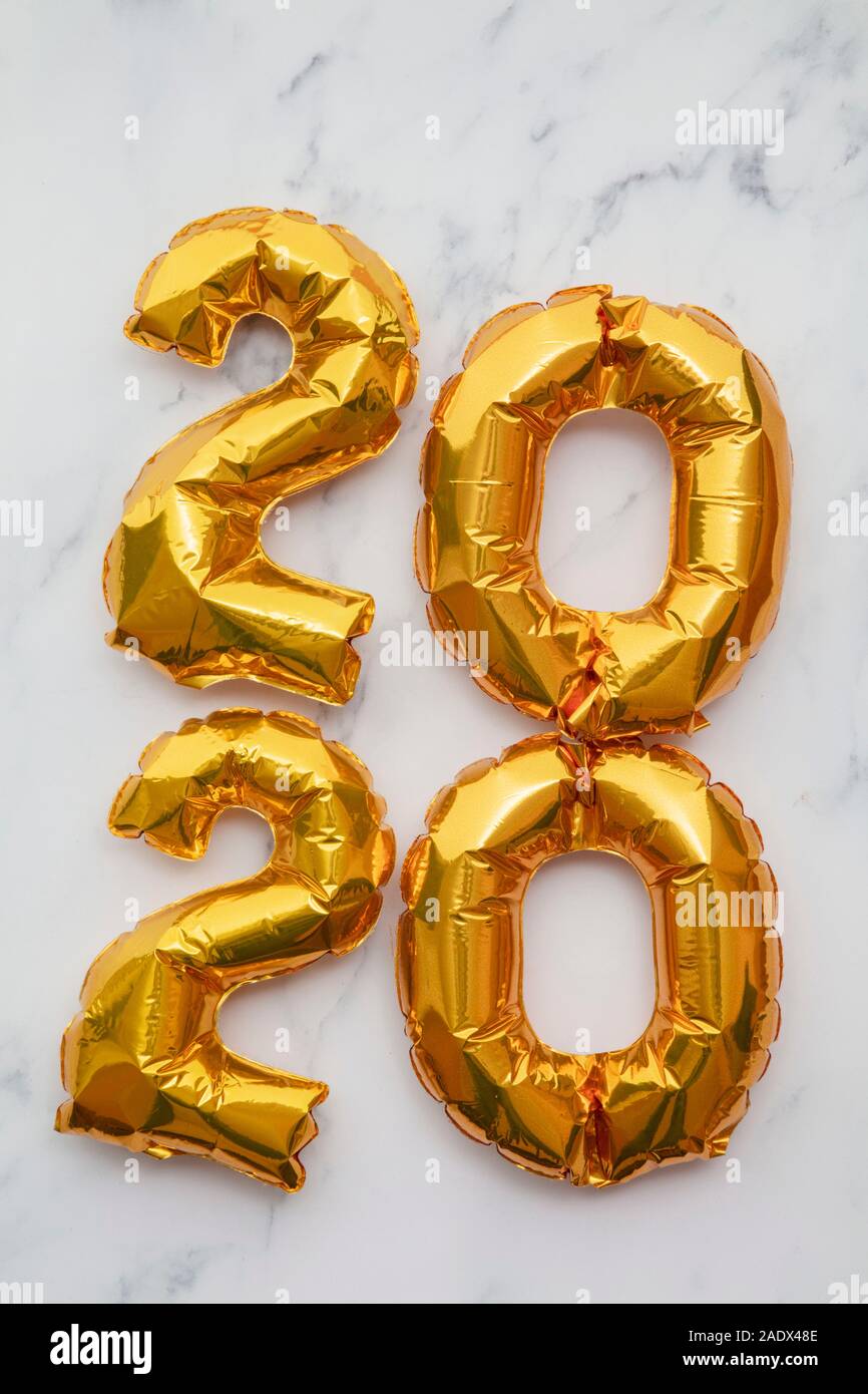 New Year 2020 celebration. Gold foil party balloons on marble ...
