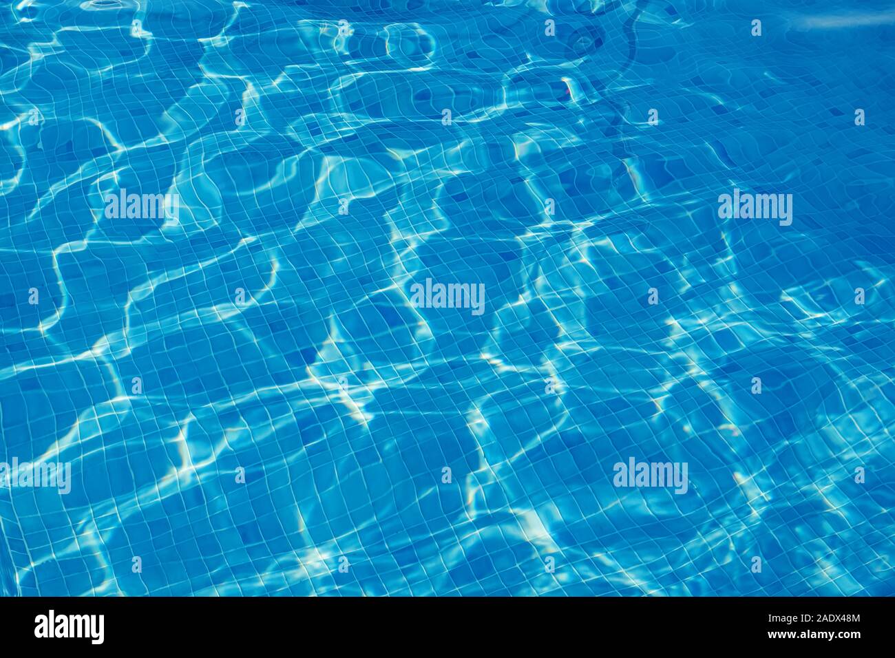 Ripple water in the swimming pool with sun reflection Stock Photo - Alamy