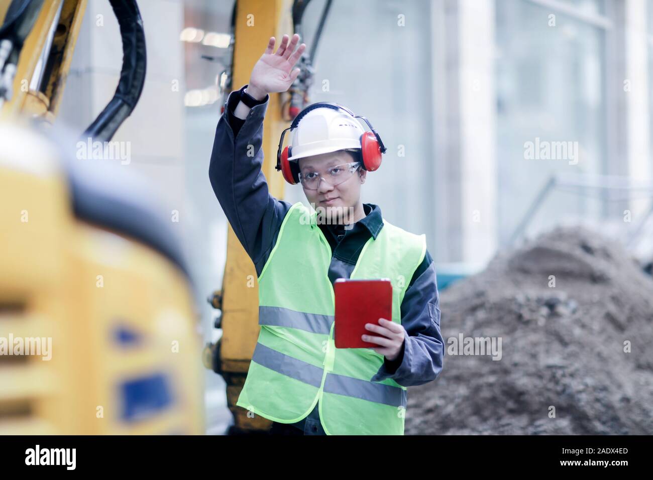 civil engineer standing in front of an excavator Stock Photo - Alamy