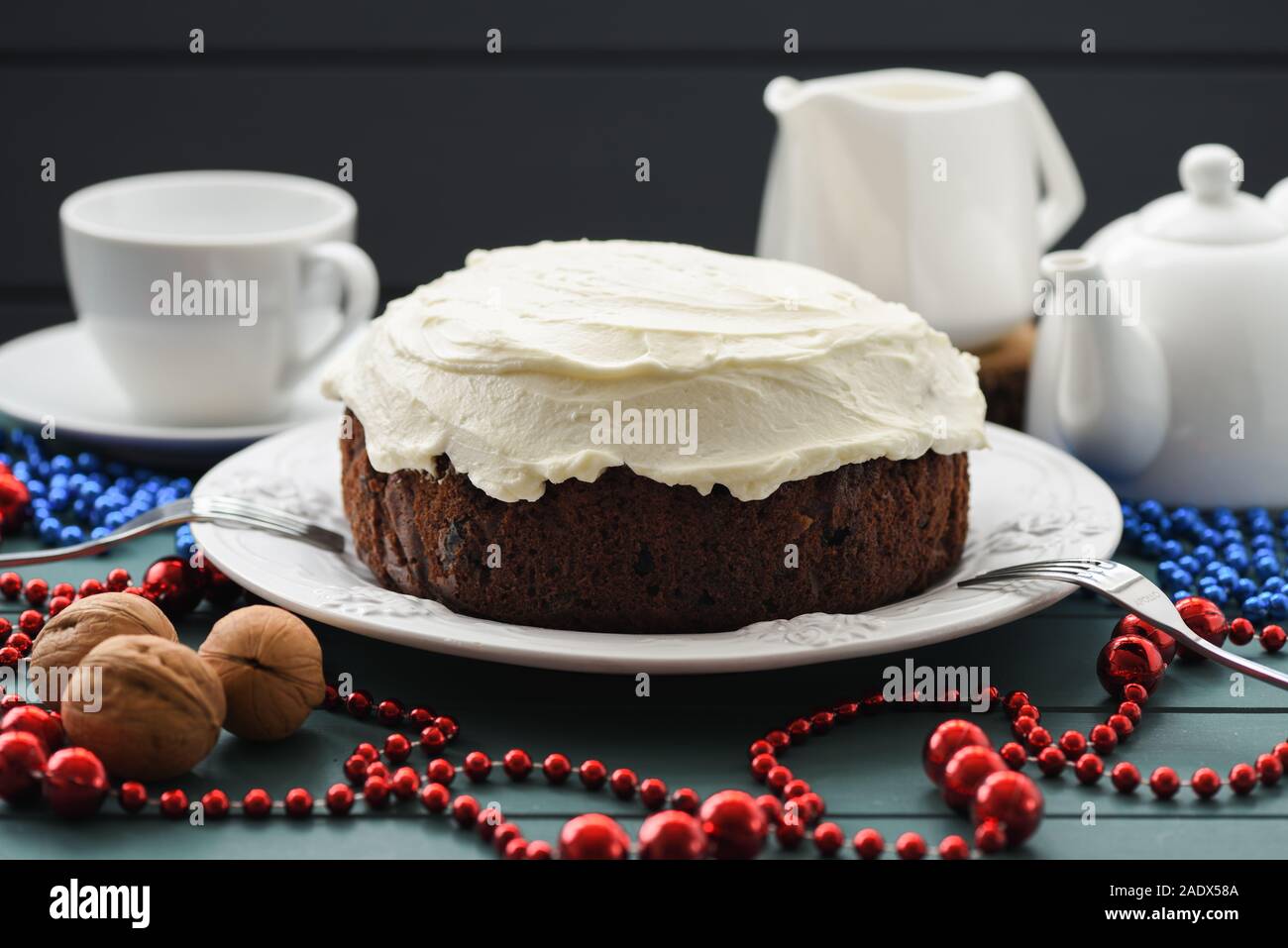 Chocolate fruit cake with cream cheese glasing decorated with garland ...