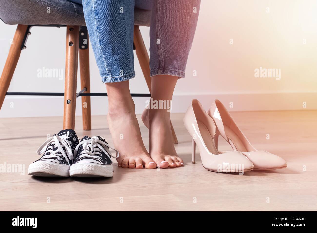 Tired businesswoman changing shoes at workplace in office Stock Photo ...