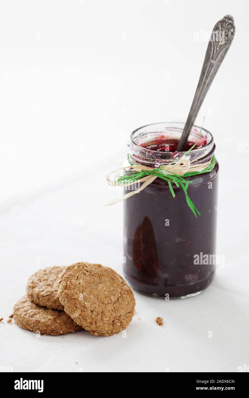 Home made red fruit jam with oat biscuits Stock Photo - Alamy