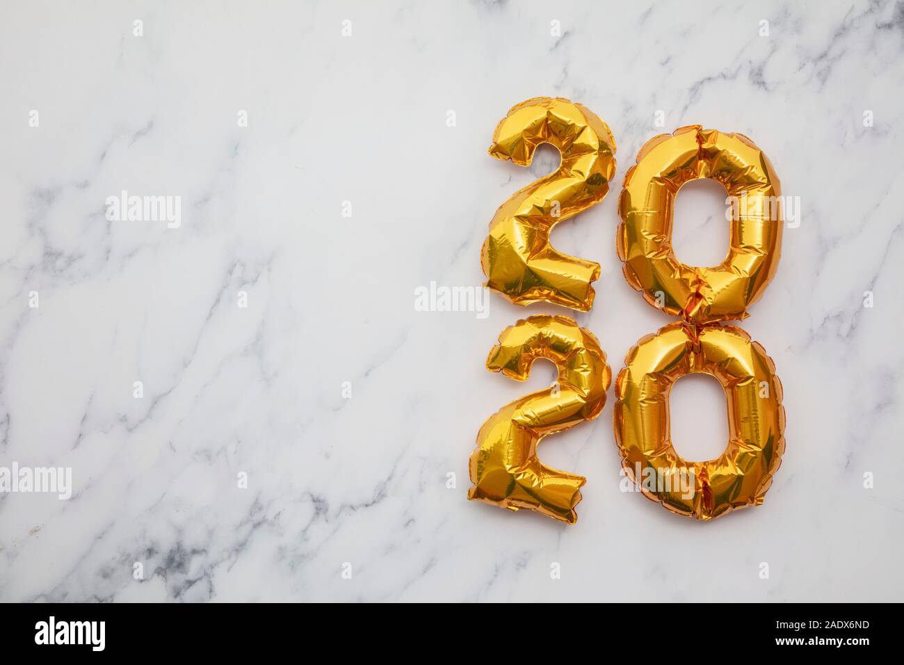 New Year 2020 celebration. Gold foil party balloons on marble ...
