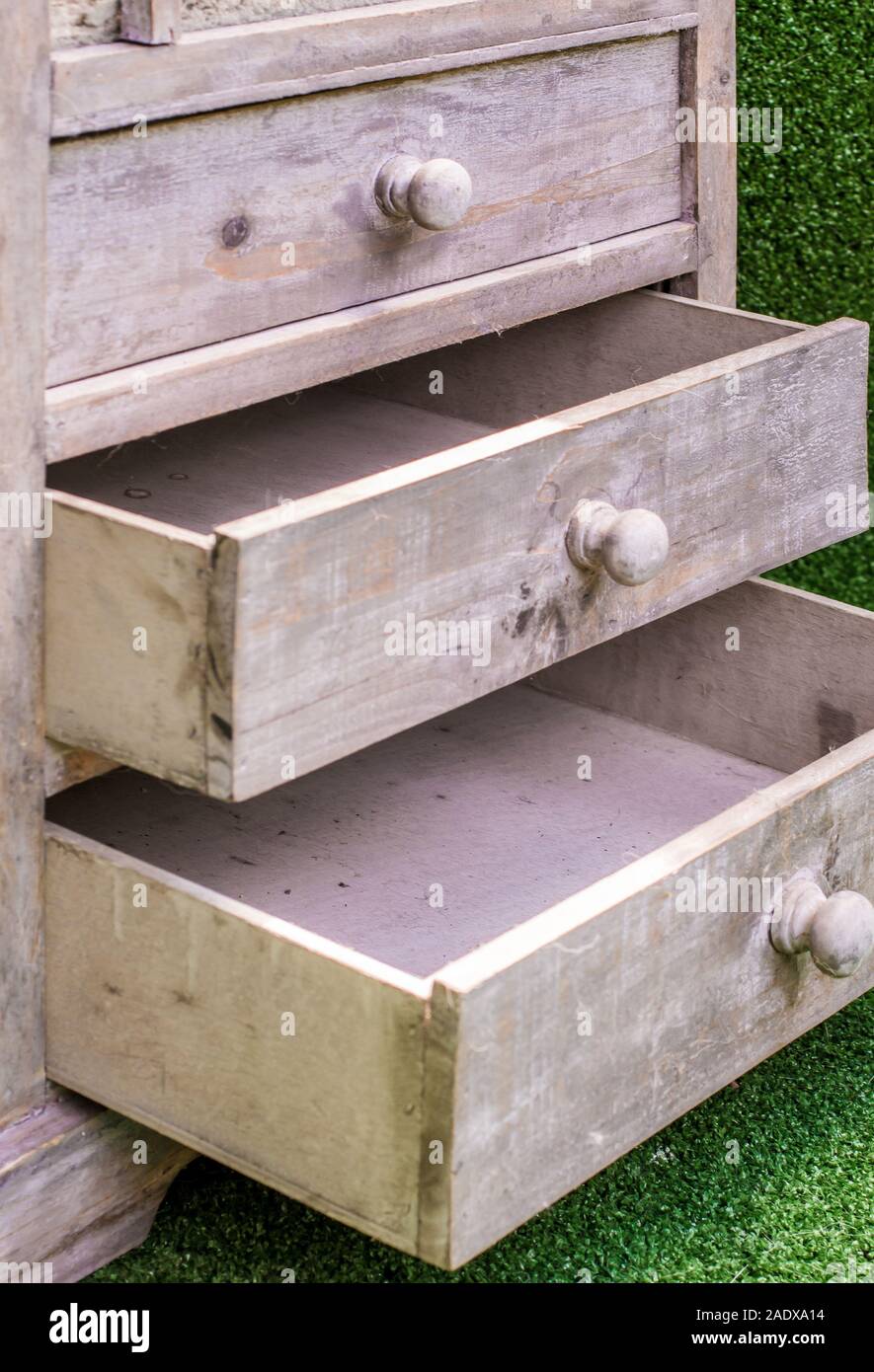 Closed and open drawers of an old wooden cabinet as a symbol for drawer ...