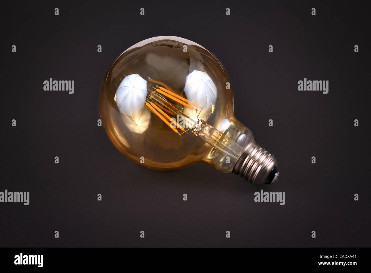 Big round LED light bulb on black background Stock Photo - Alamy