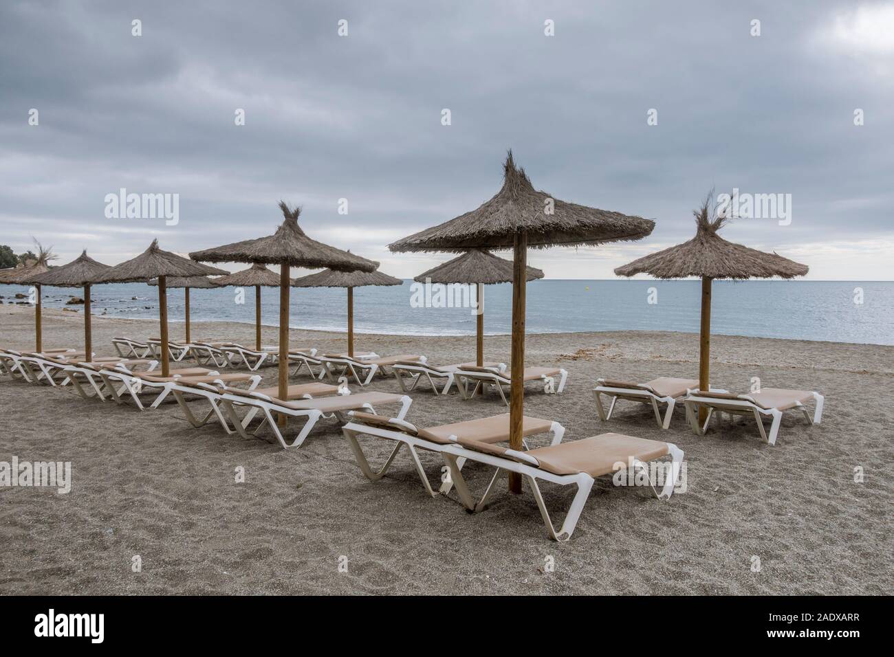Empty spanish Beach with parasols.on a clouded day, Andalusia, Spain ...
