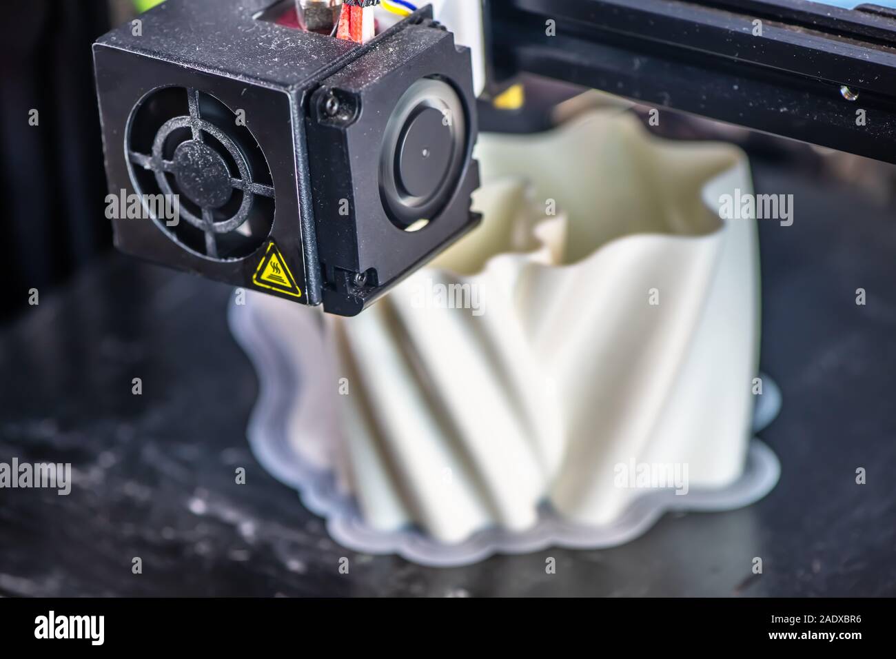 The 3D printer prints the model out of white plastic. modern technology ...
