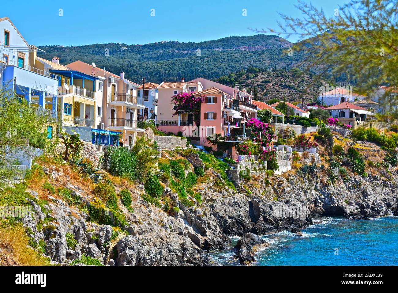 Colourful houses cling to the cliff top in the beautiful coastal ...