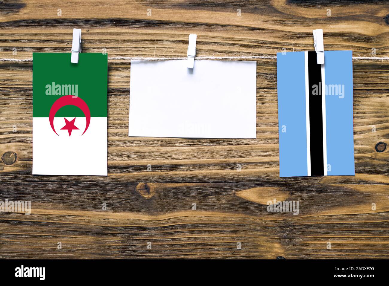 Hanging flags of Algeria and Botswana attached to rope with clothes ...