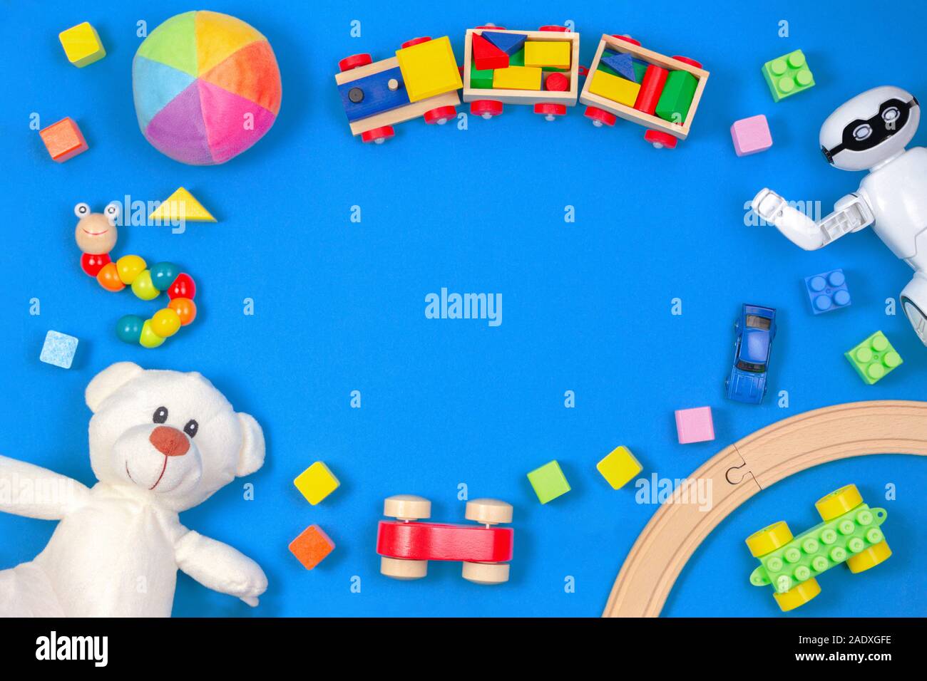 Kids toys background. White teddy bear, wooden train, toy car, robot ...