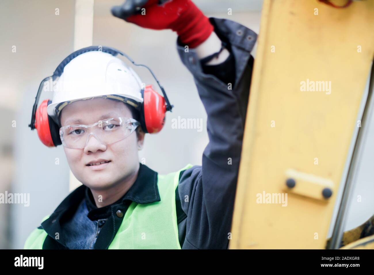 civil engineer standing in front of an excavator Stock Photo - Alamy