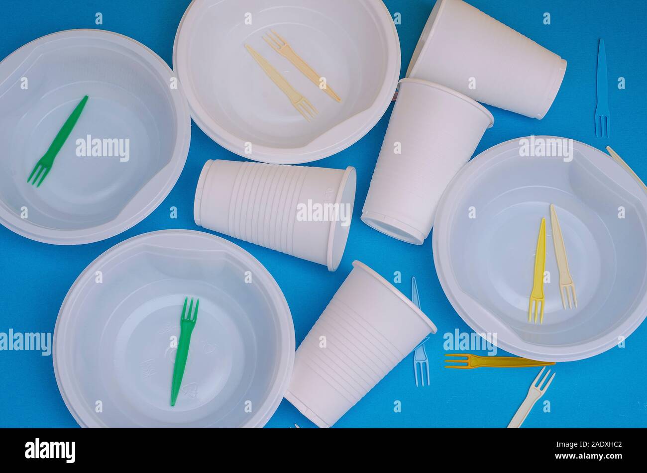 Disposable tableware on a blue background. Concept: ecology ...