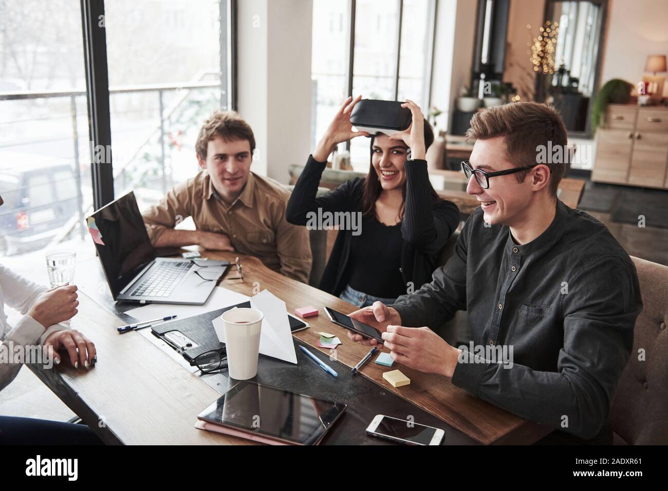 Beautiful girl with virtual reality glasses. Having fun in the office ...