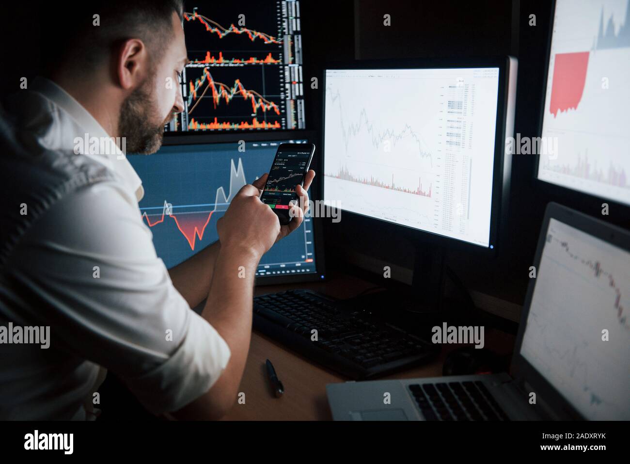 New modern digital technologies. Bearded man in white shirt works by ...
