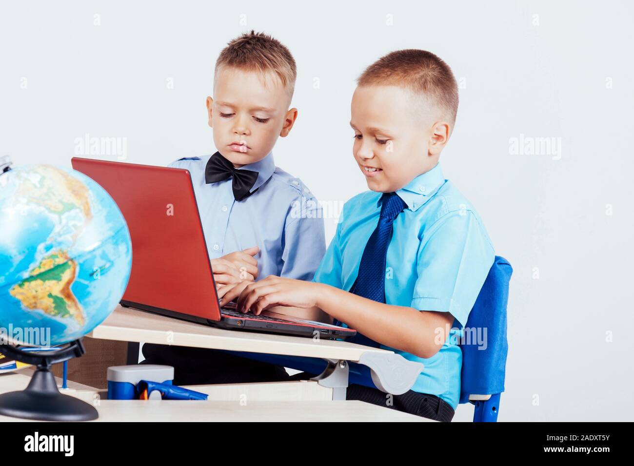 two boys sit at the computer training school Stock Photo - Alamy