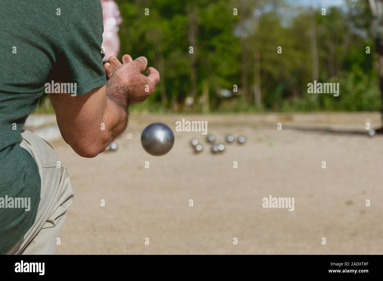 senior people prepared to throw the boules ball in a park in outdoor ...