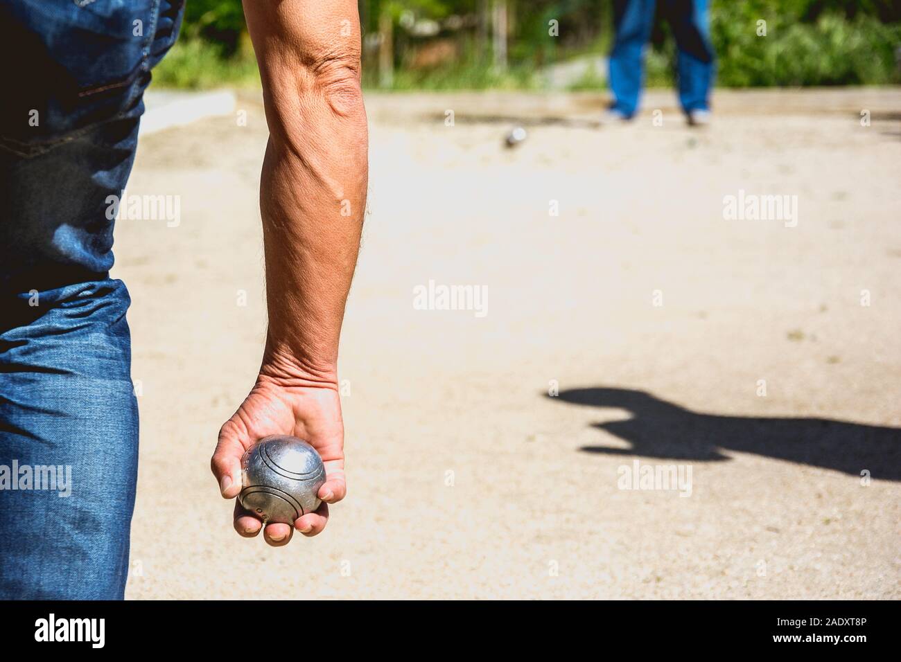 senior people prepared to throw the boules ball in a park in outdoor ...