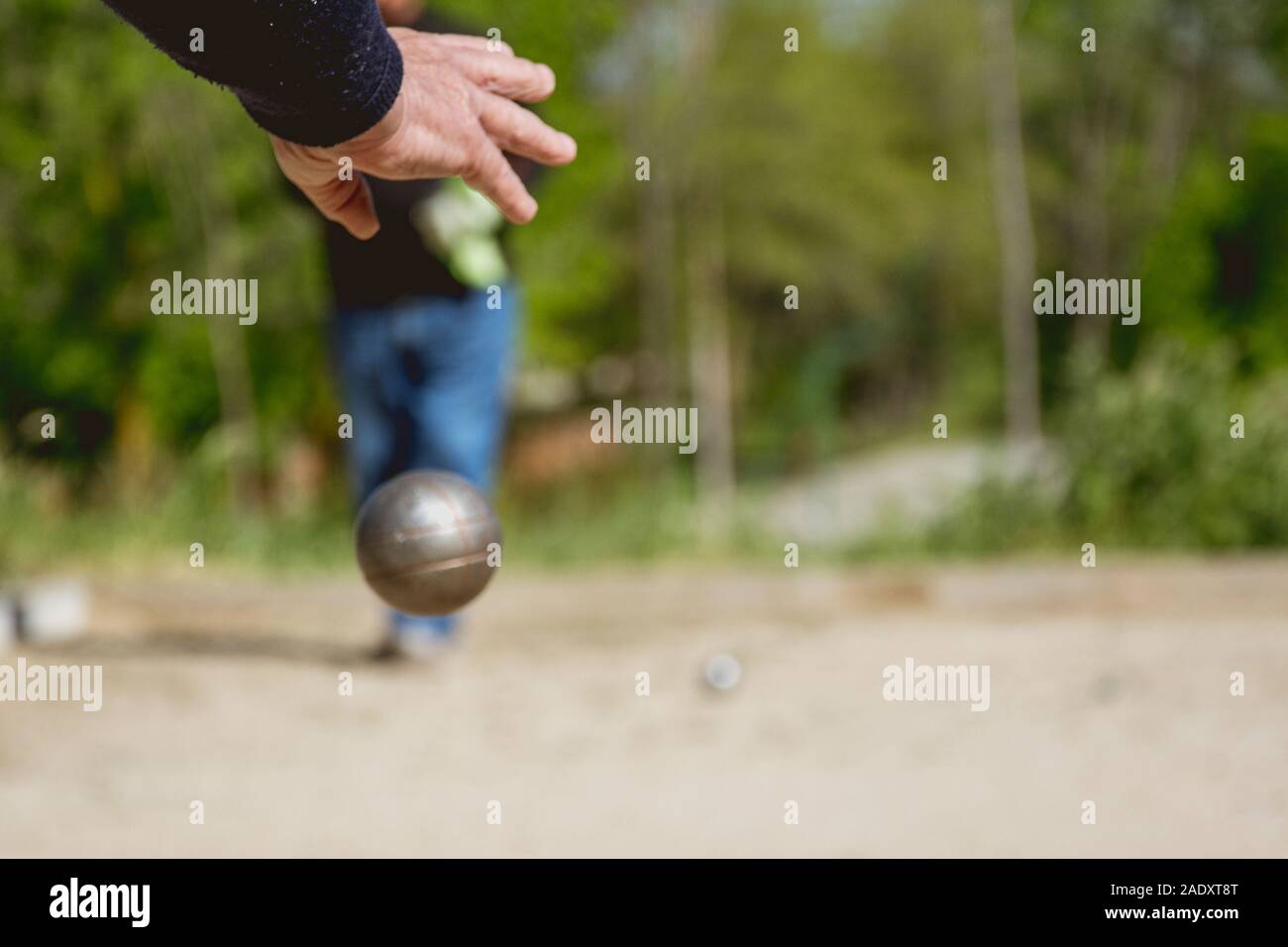 senior people prepared to throw the boules ball in a park in outdoor ...