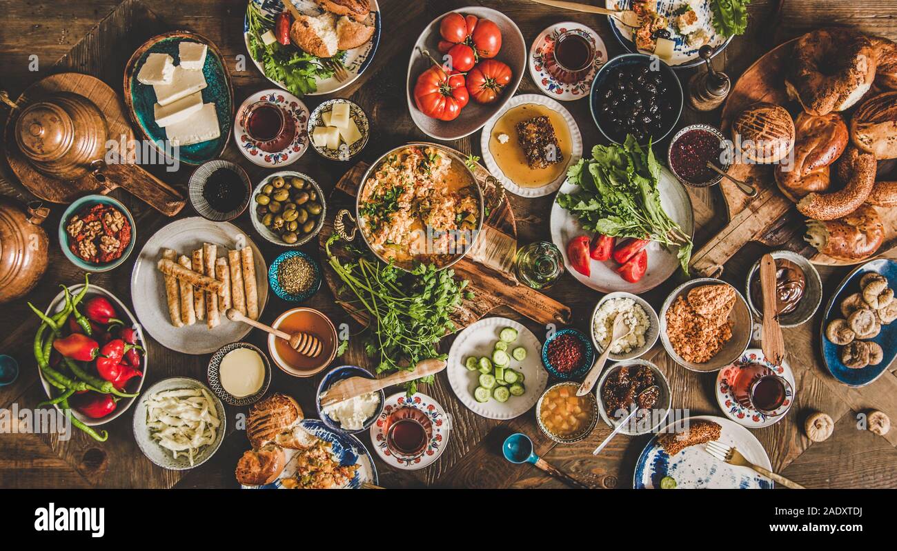 Flat-lay of traditional Turkish breakfast table with various snacks ...