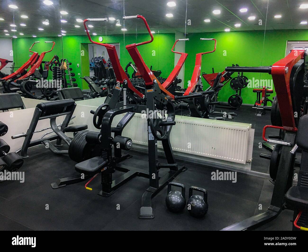 Gym or fitness hall interior with equipment. Machines, barbells, rods ...