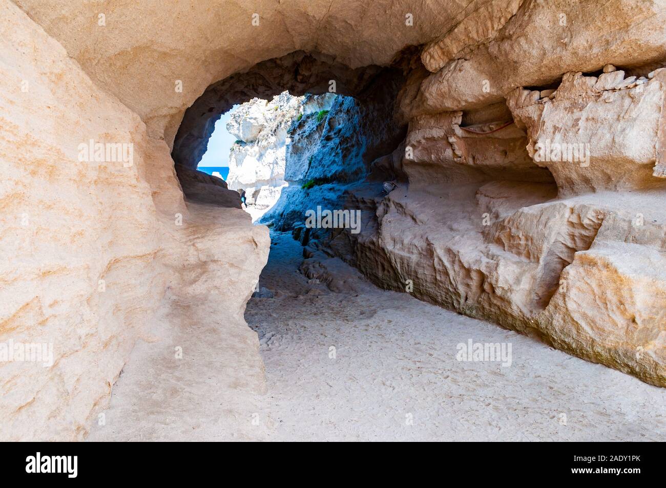 Side view on the round entrance tunnel to unique sea cave in massive ...
