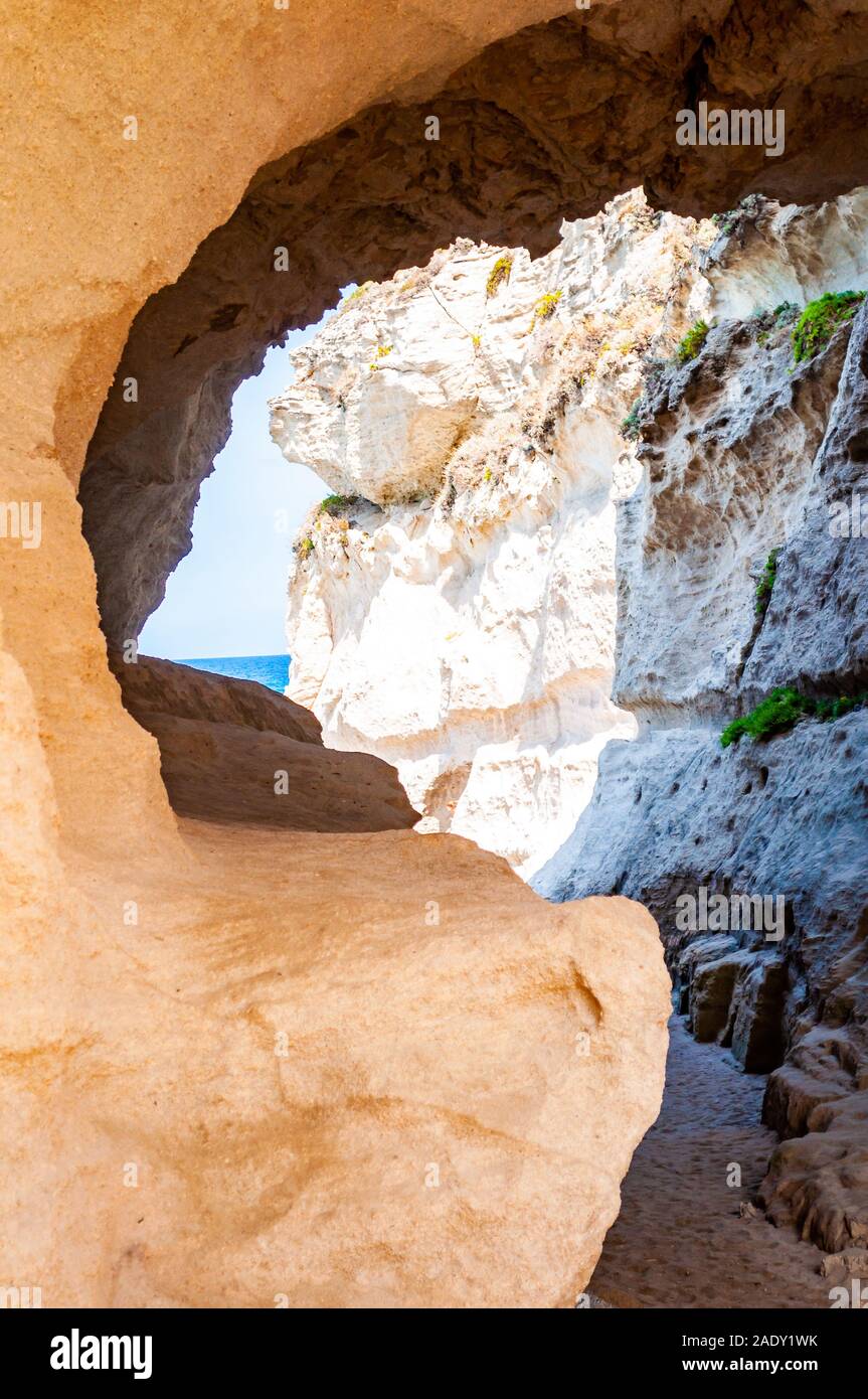 Side view on the round entrance tunnel to unique sea cave in massive ...