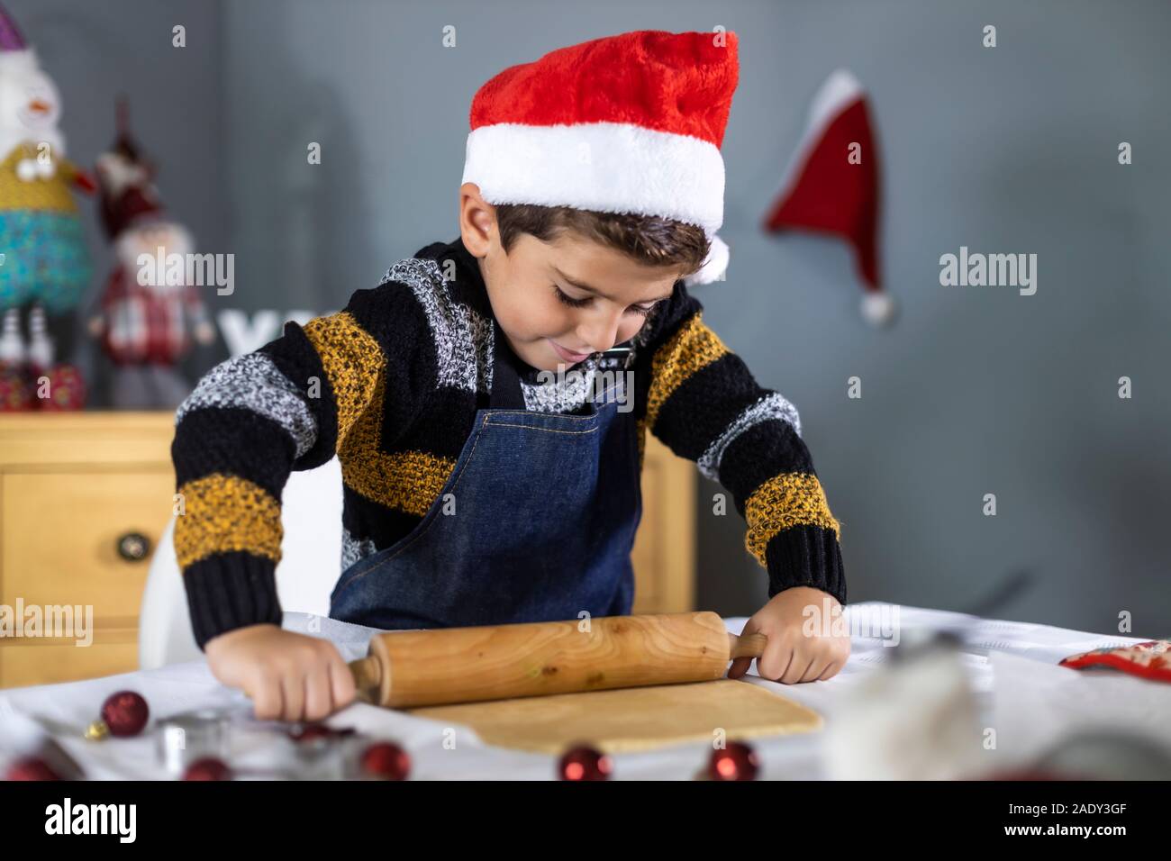 Beautiful boy making cookies on Christmas Day Stock Photo - Alamy