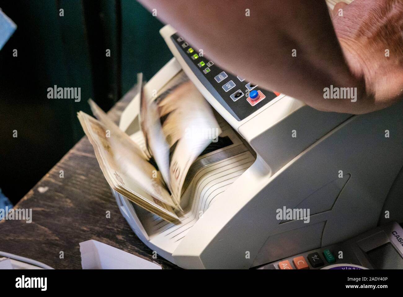 Counting money on banknote counting machine Stock Photo - Alamy
